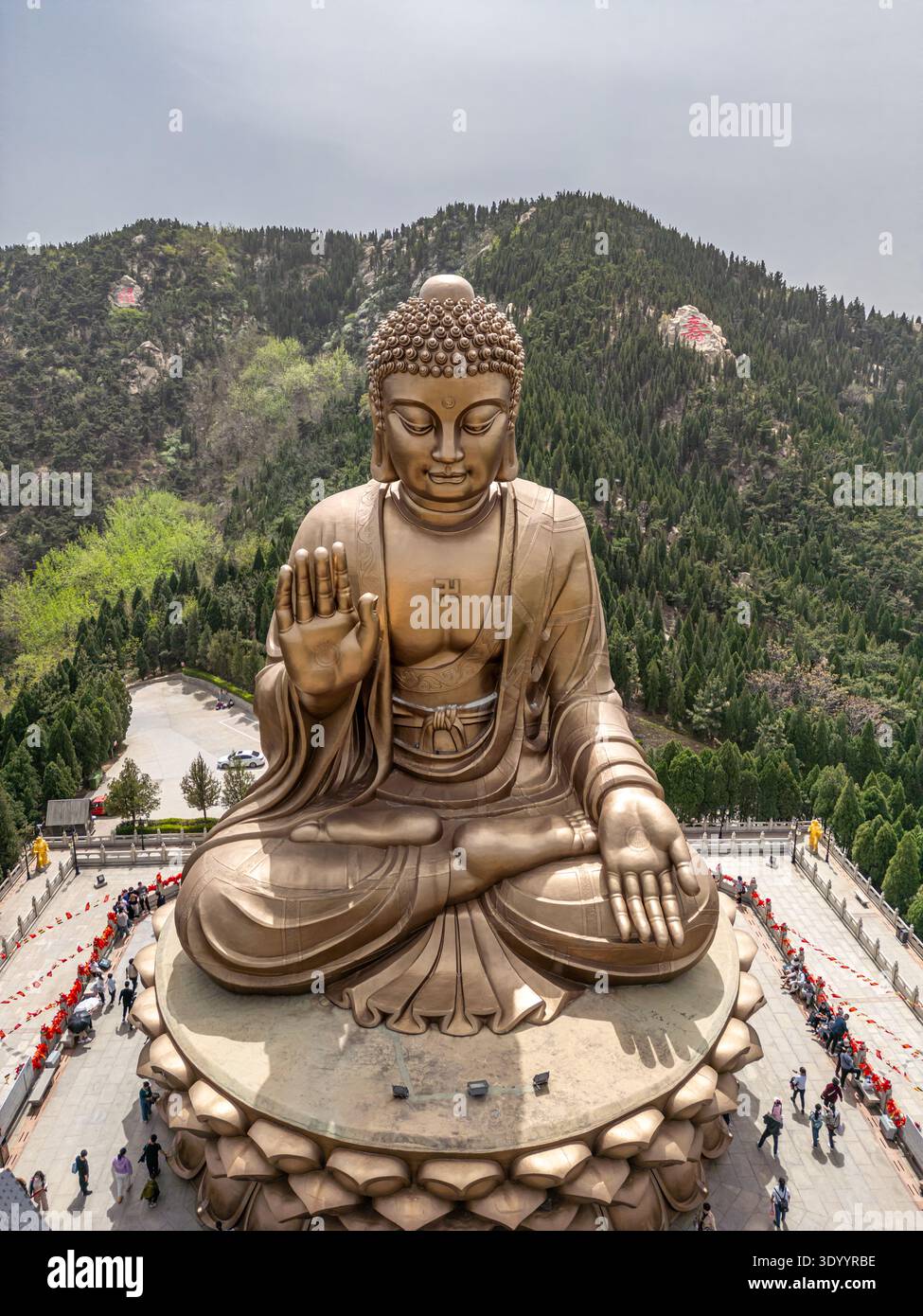 A large sitting Buddha statue on a lotus flower at Nanshan Mountain ...