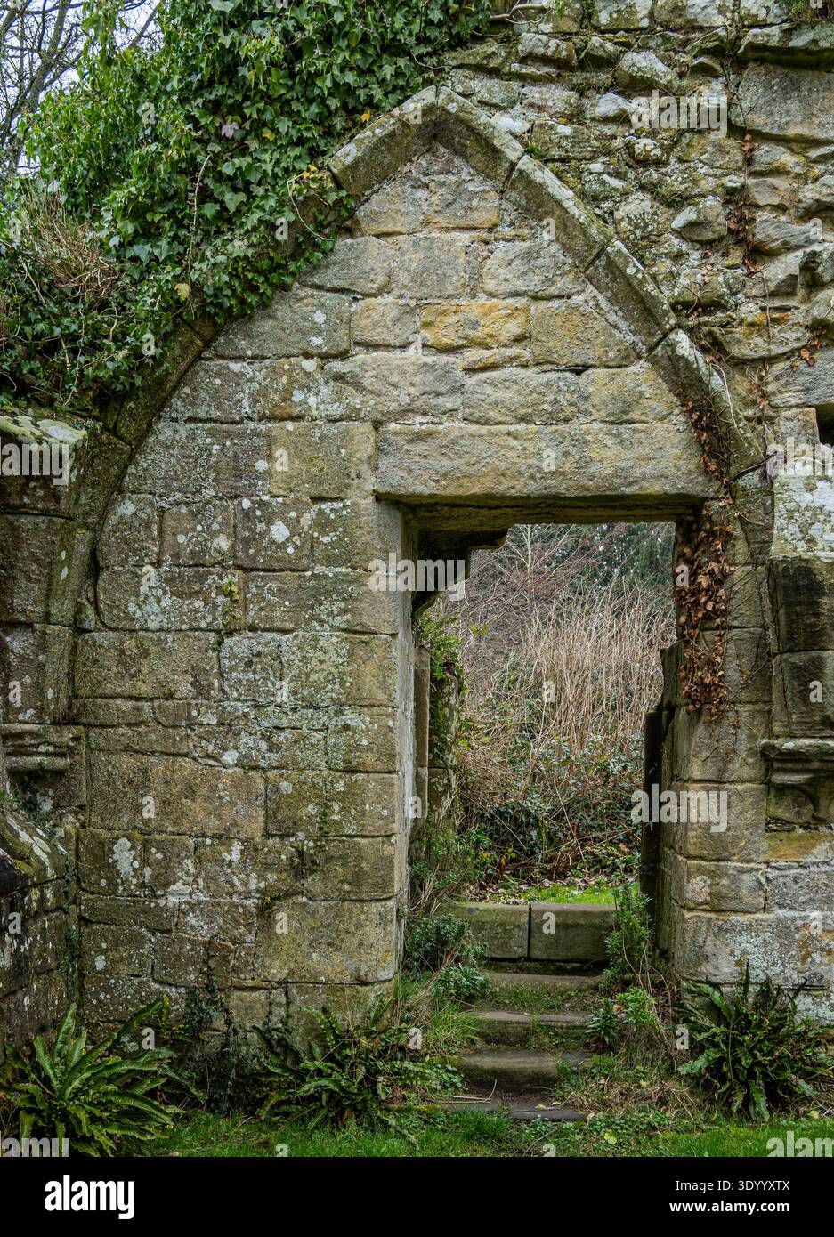 Medieval monastery arch with weathered limestone stonework Stock Photo ...