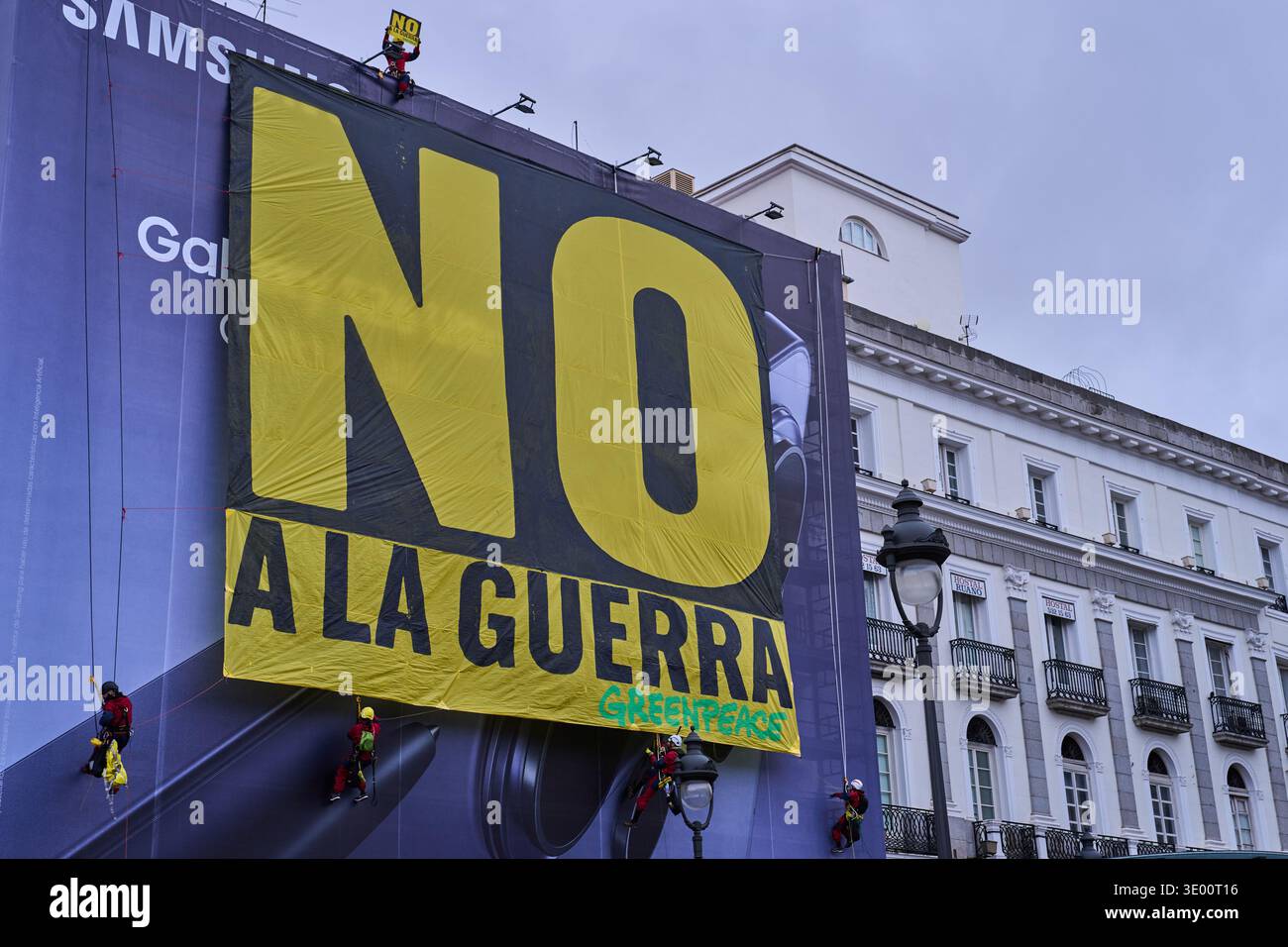 Greenpeace activists hang a banner reading in Spanish, "Not to war" in ...