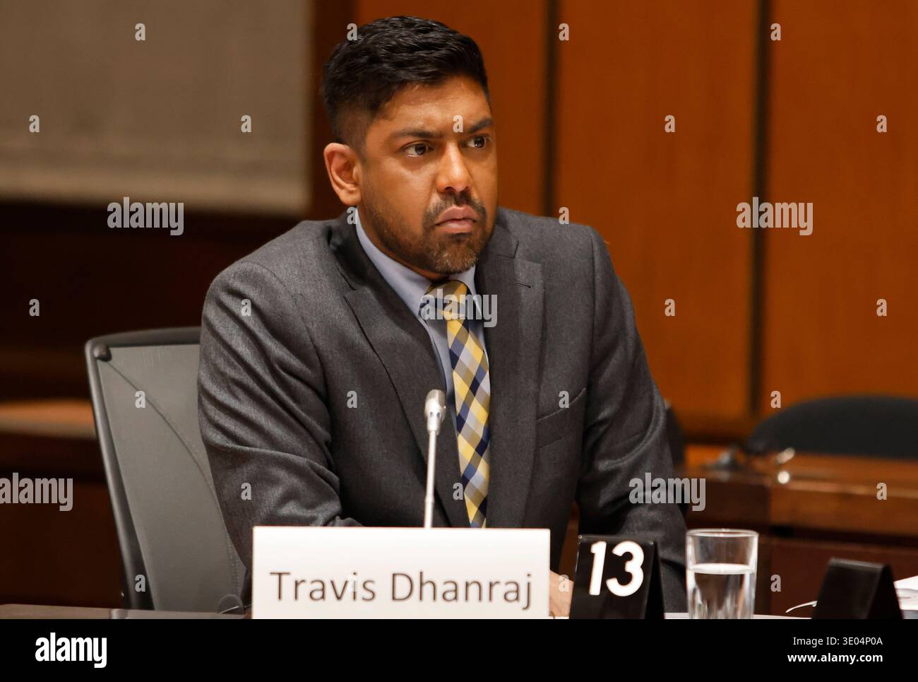 Former CBC journalist Travis Dhanraj waits to appear before the ...