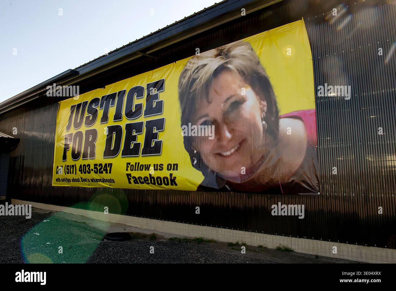 FILE - A banner shows a photo of missing woman Dee Warner in Tipton ...