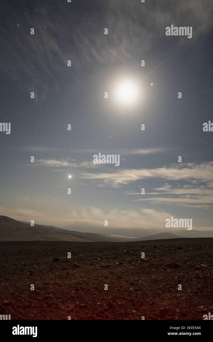 Starry night scene in the Atacama Desert featuring a luminous full moon ...