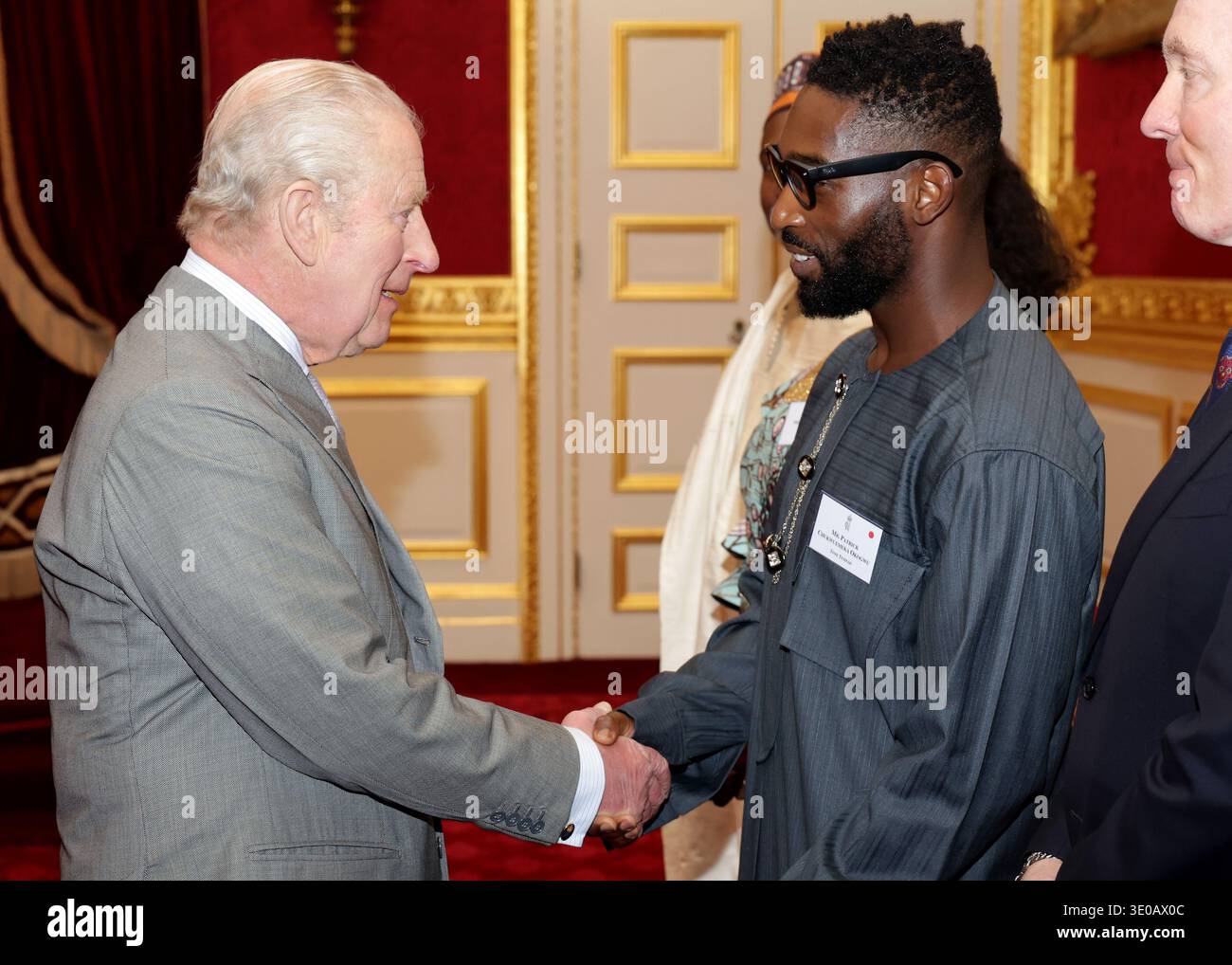 Britain's King Charles III speaks with Patrick Chukwuemeka Okogwu aka ...