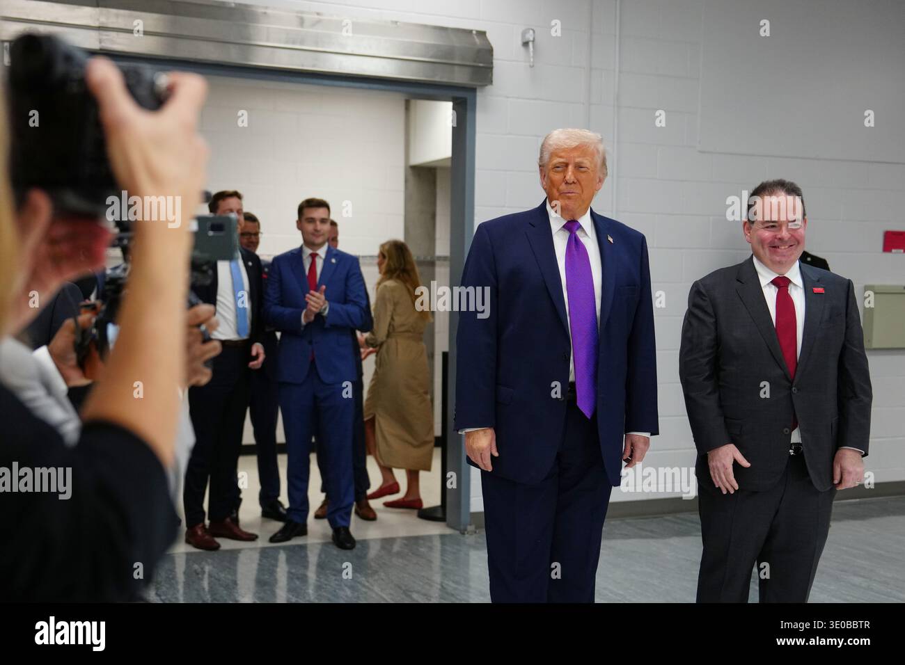 President Donald Trump walks with Marc Casper, chairman and CEO, of ...