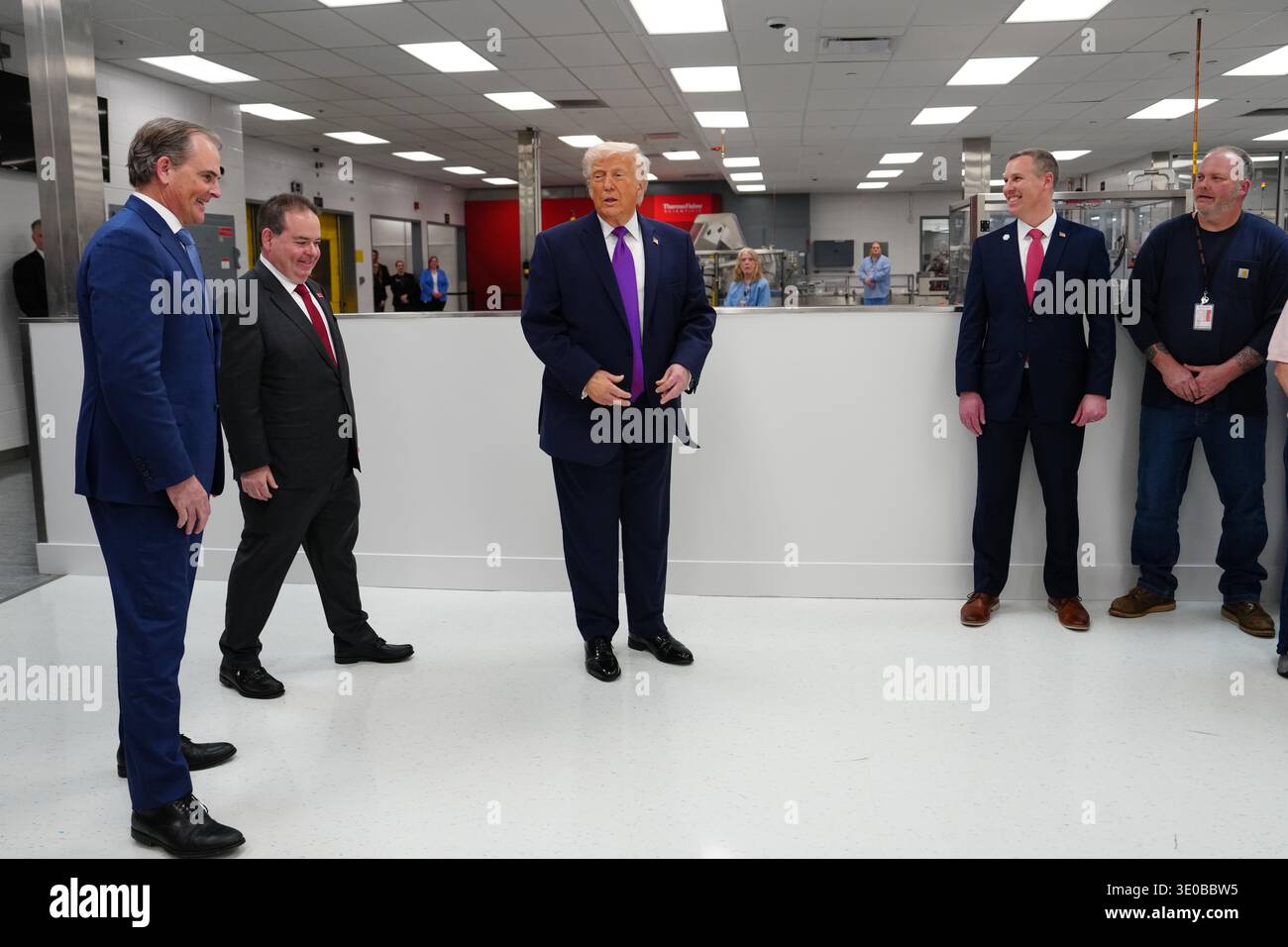 President Donald Trump walks with Marc Casper, chairman and CEO, of ...