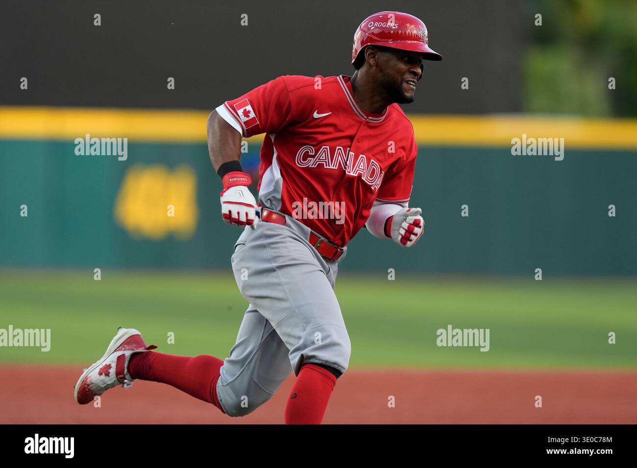Canada's Otto Lopez runs toward home plate to score against Cuba during ...