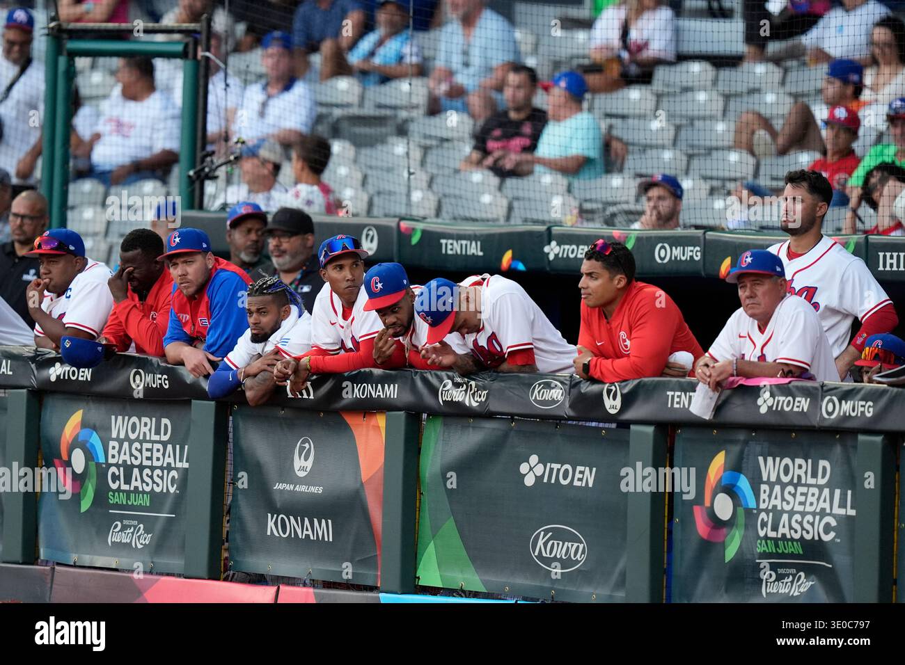 Cuban players lean in the dugout during the ninth inning of a World ...