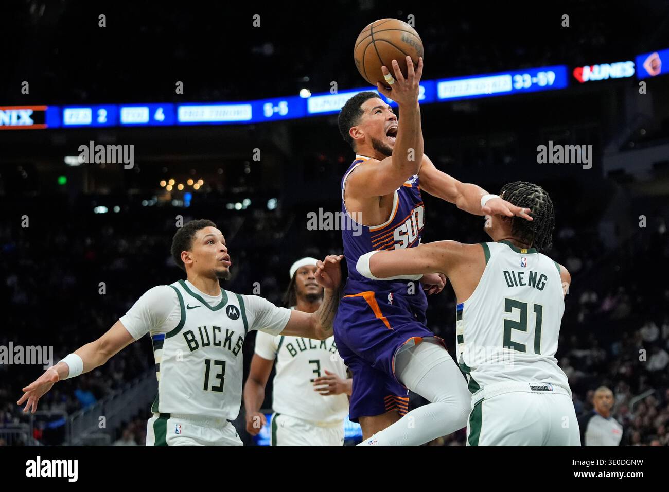 Phoenix Suns' Devin Booker shoots against Milwaukee Bucks' Ousmane ...