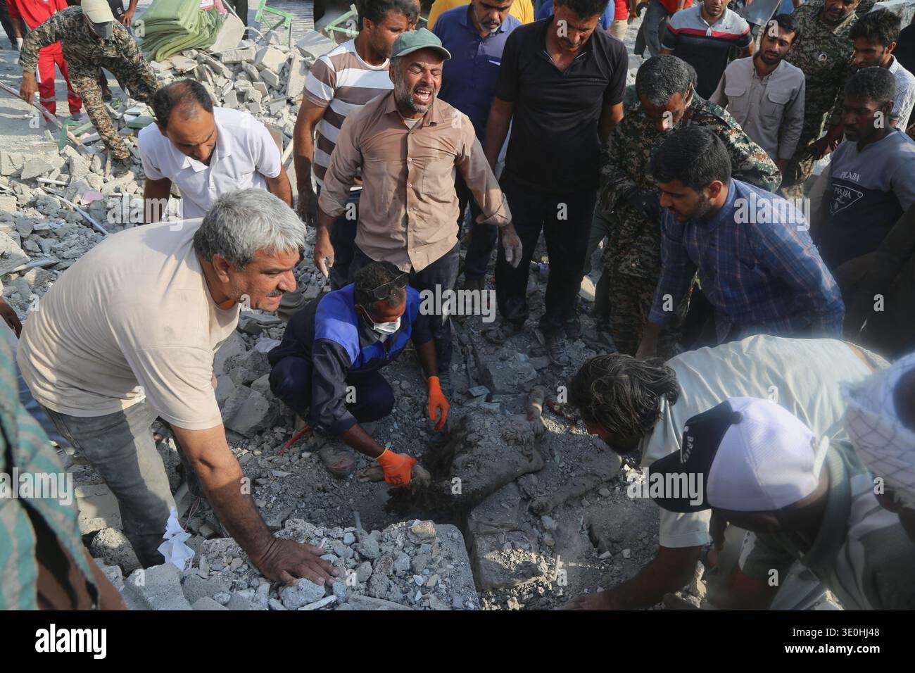 FILE - Rescue workers and residents search through the rubble in the ...