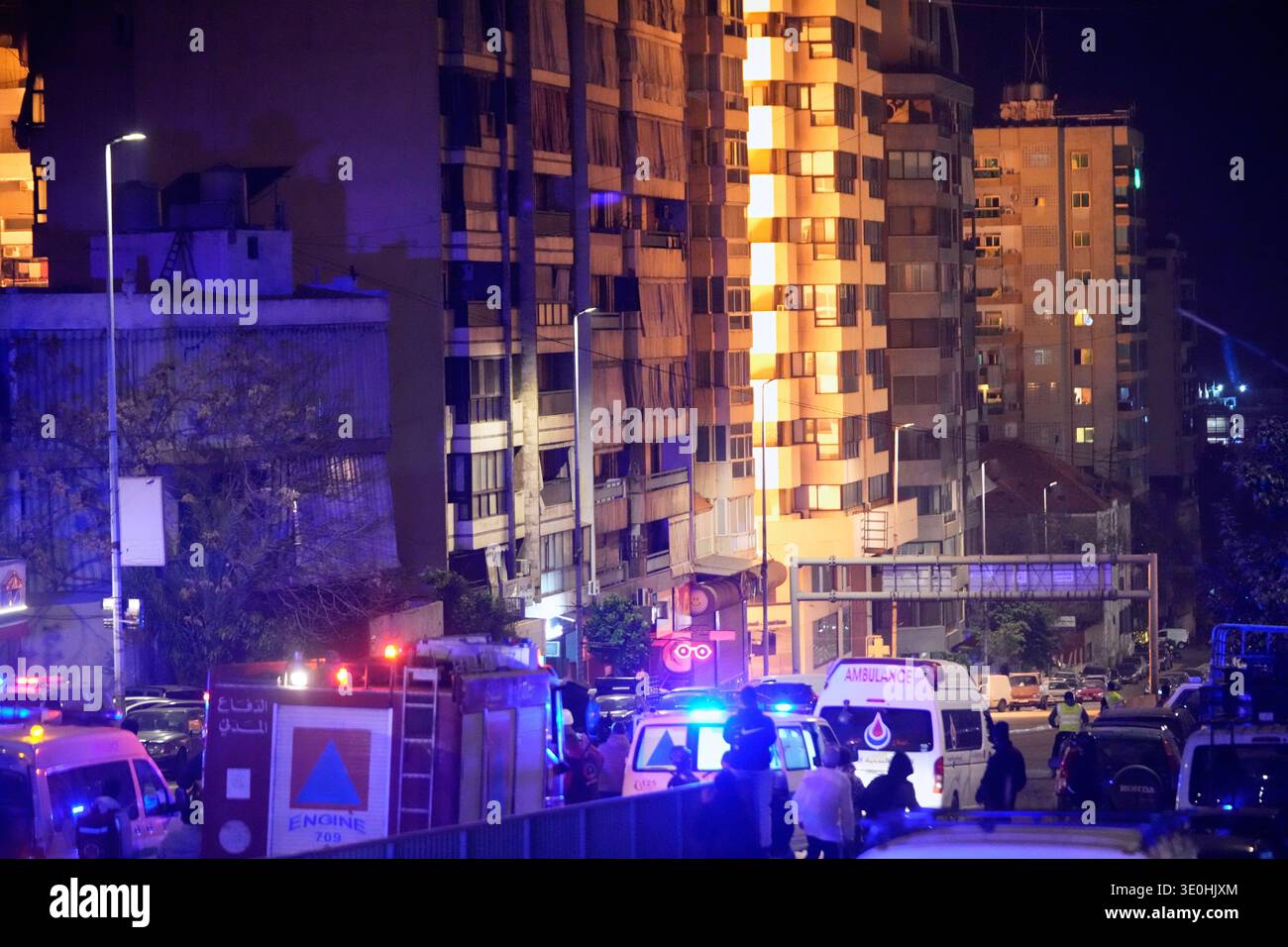 A flash from an explosion is seen behind a building during an Israeli ...