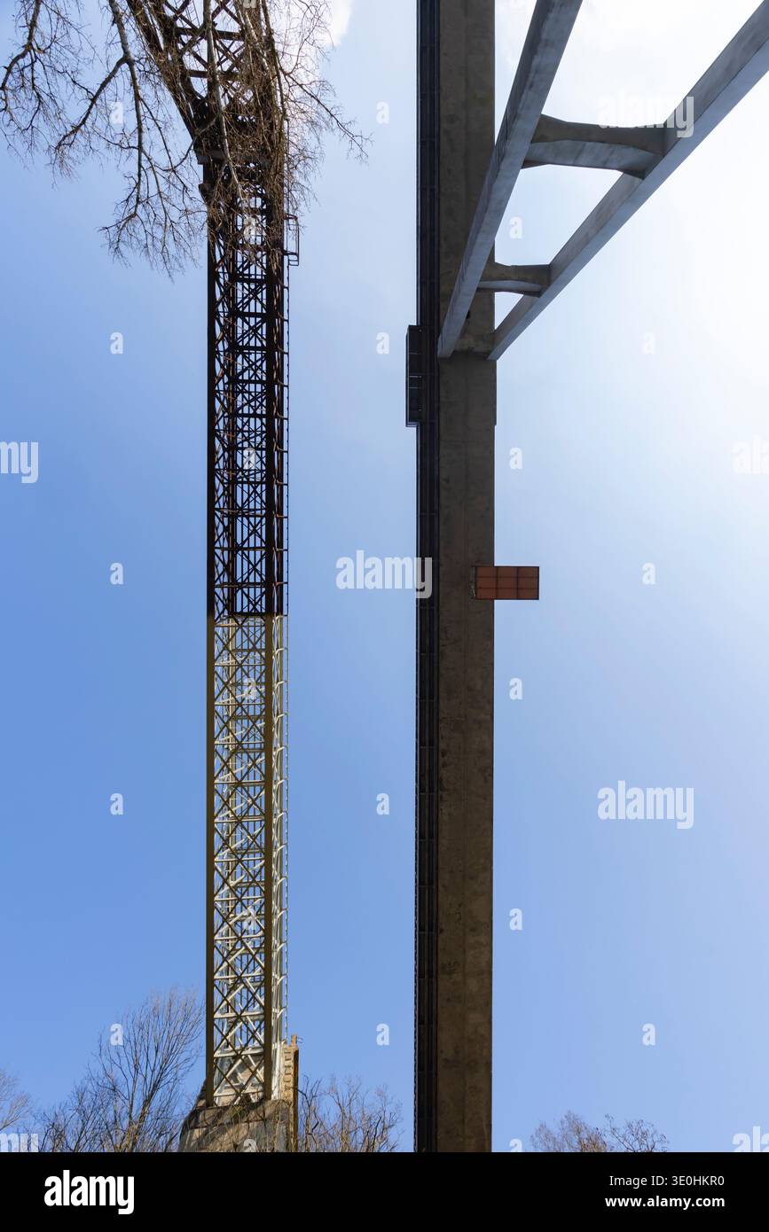 Contrasting metal lattice and concrete pylons reaching into a clear ...