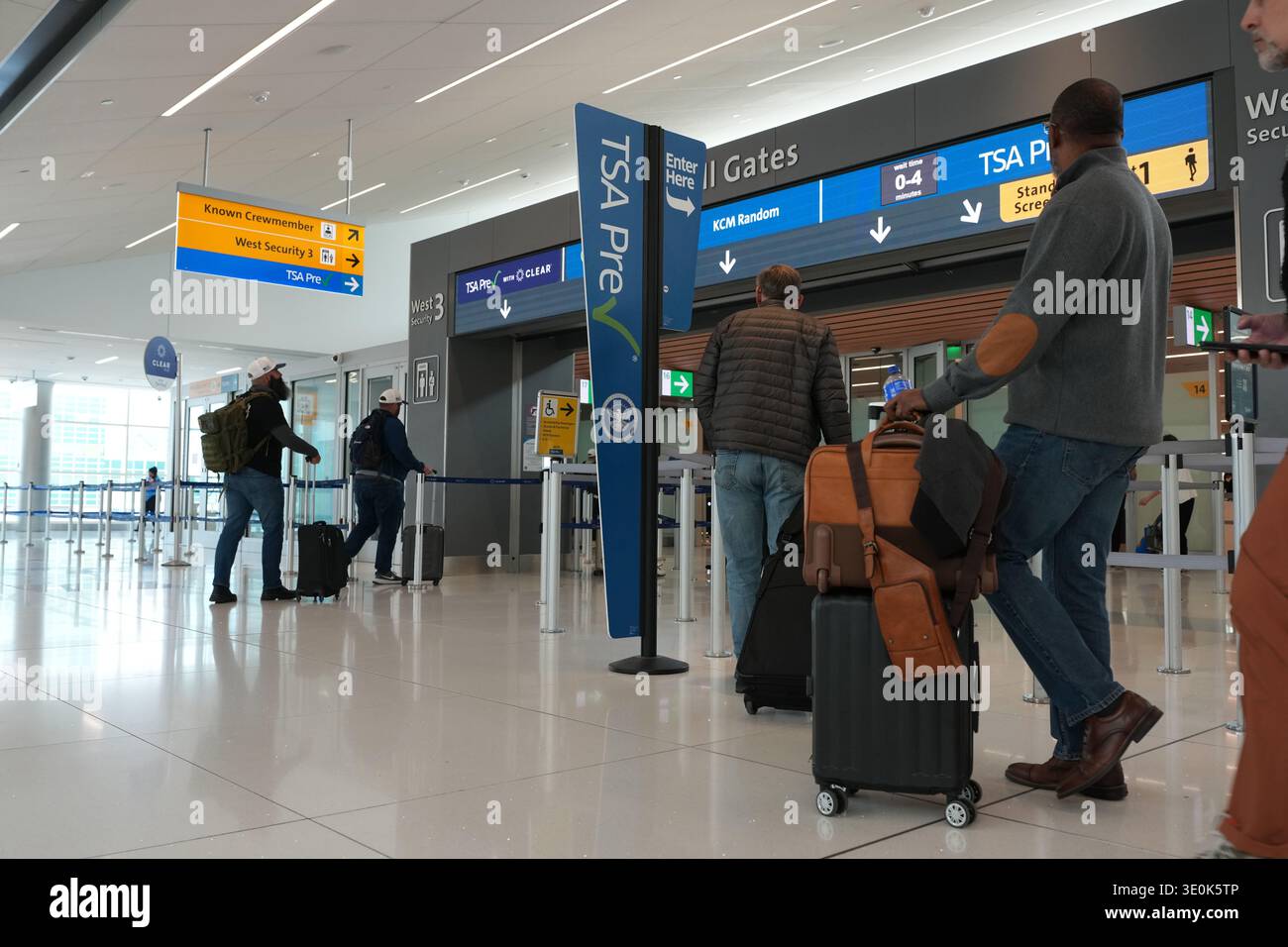 Travelers enter the west security checkpoint in Denver International ...