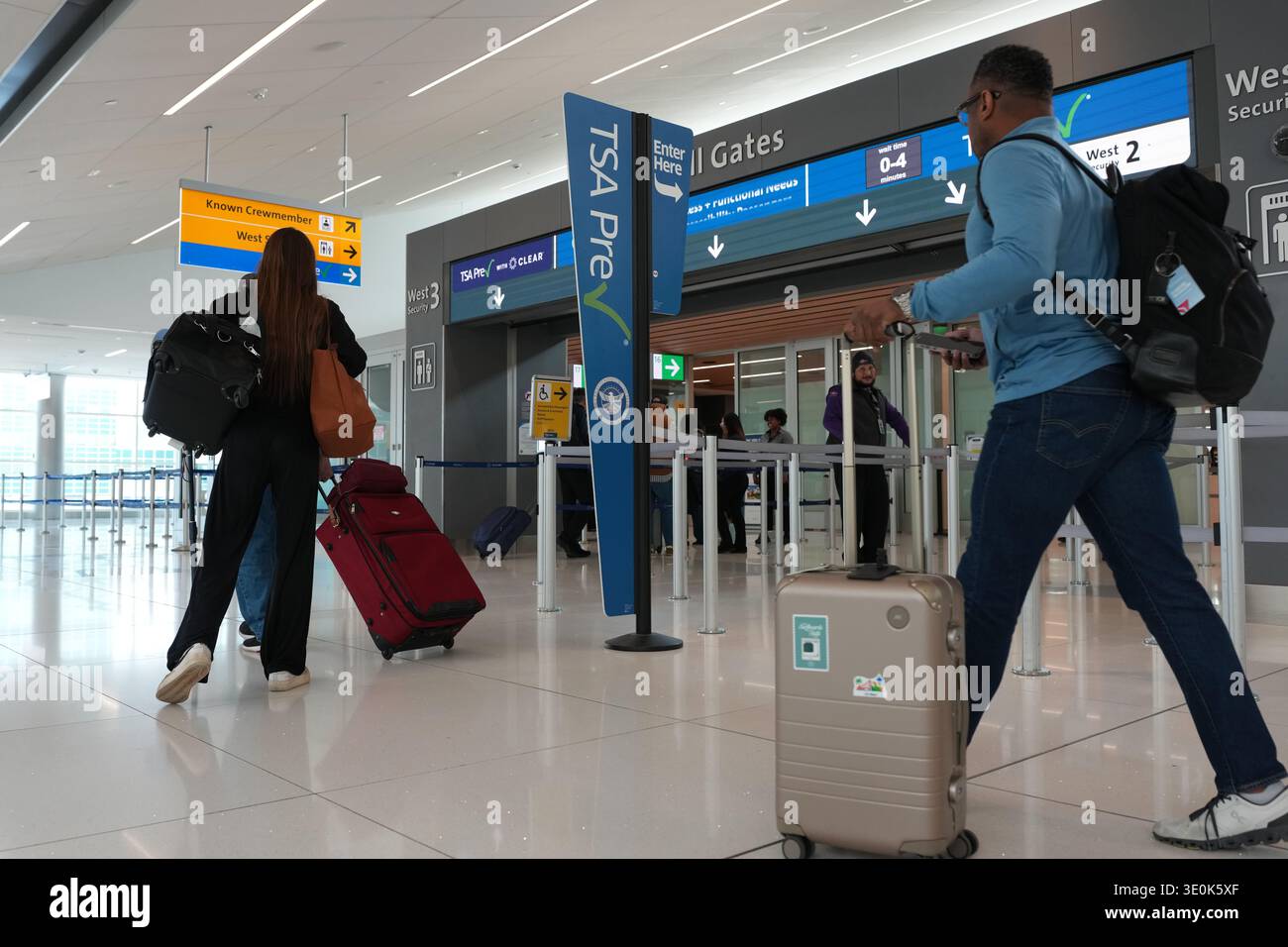 Travelers enter the west security checkpoint in Denver International ...