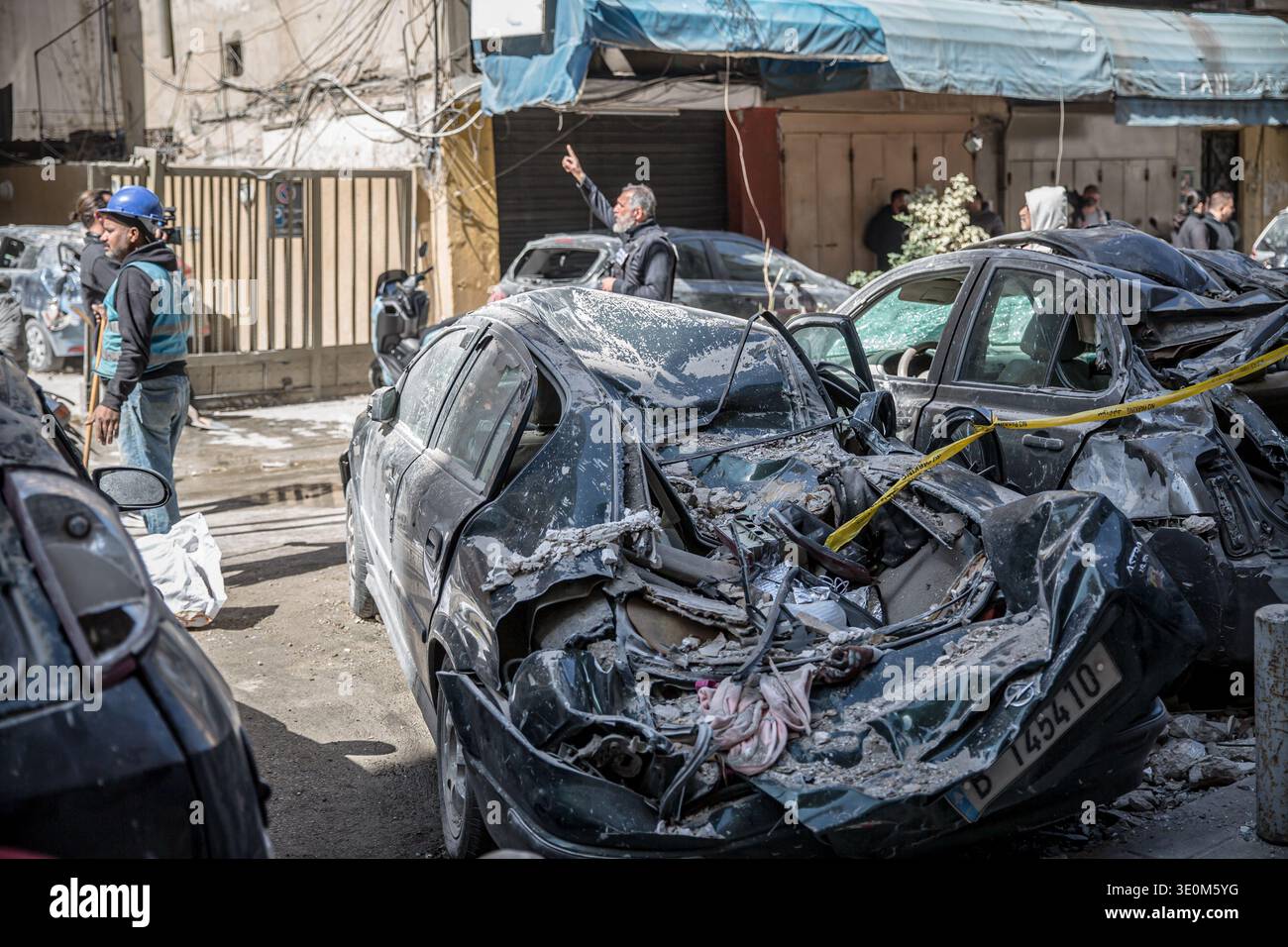 Mangled cars on the street following an Israeli airstrike in Aisha ...