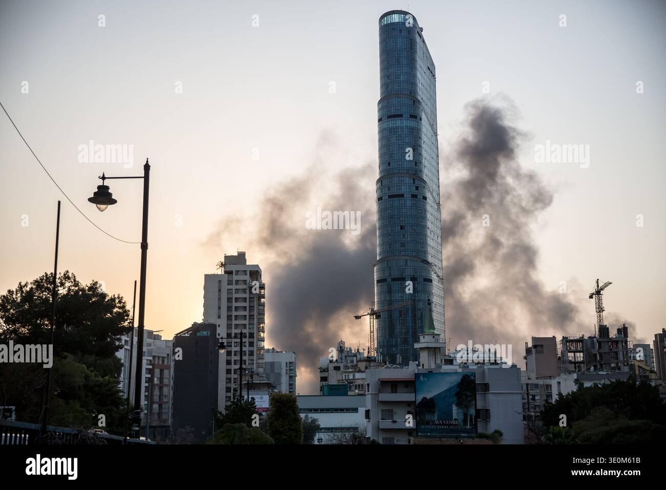 Smoke from an airstrike rises behind Sama Beirut. Israel and Hezbollah ...