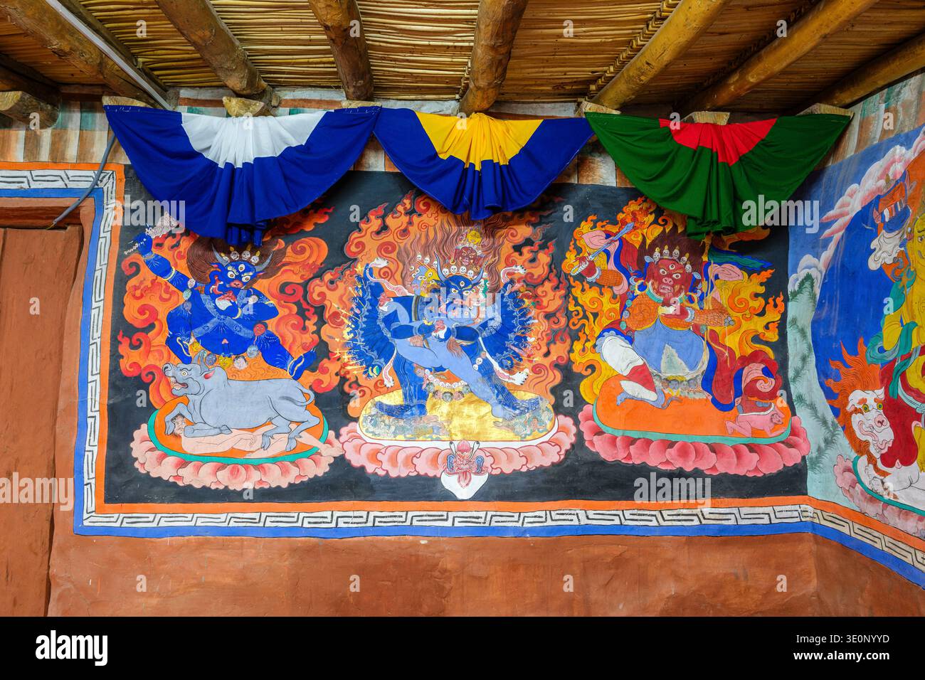 Vivid Buddhist murals depicting wrathful deities are displayed beneath ...