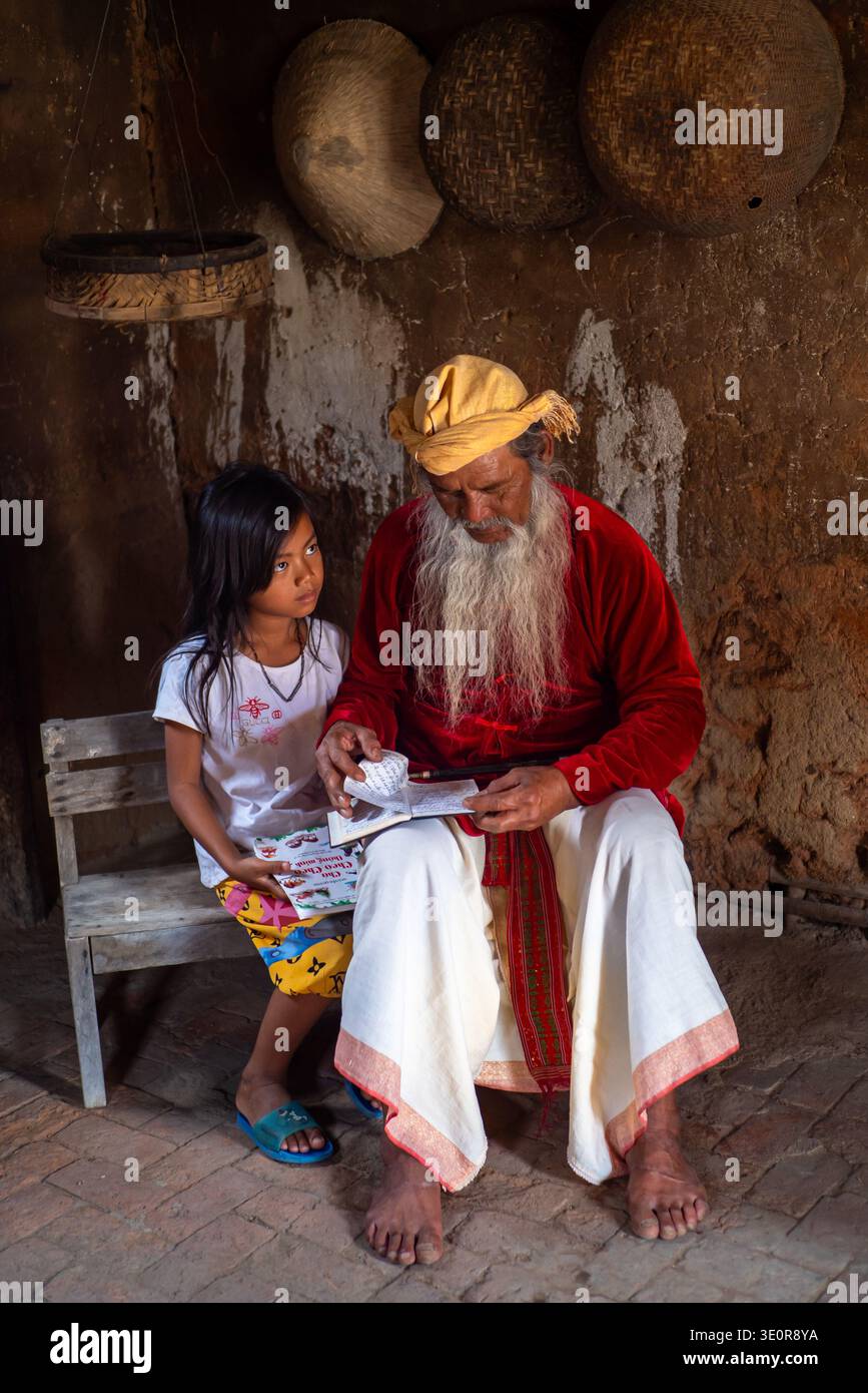 Elderly Cham master Pao playing traditional Saranai instrument in Phan ...