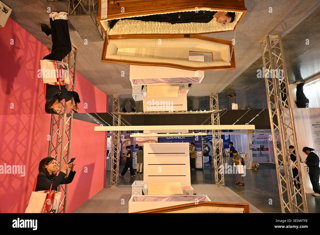 A visitor is reflected in a mirror lying inside a coffin at Death Fest ...