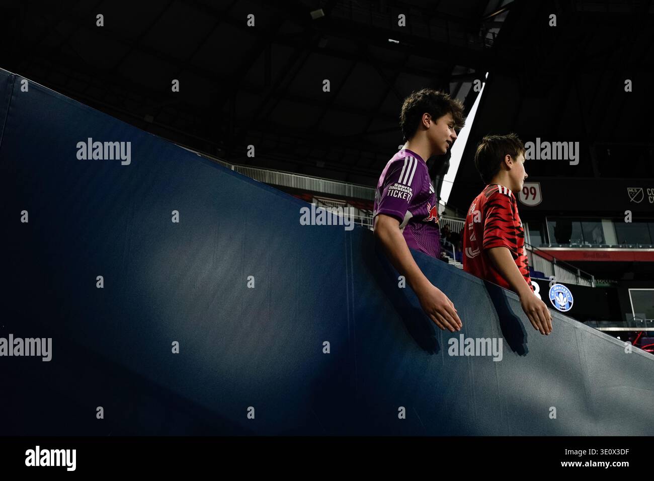 Fans slap their hands against the tarp in support of the Red Bull New ...