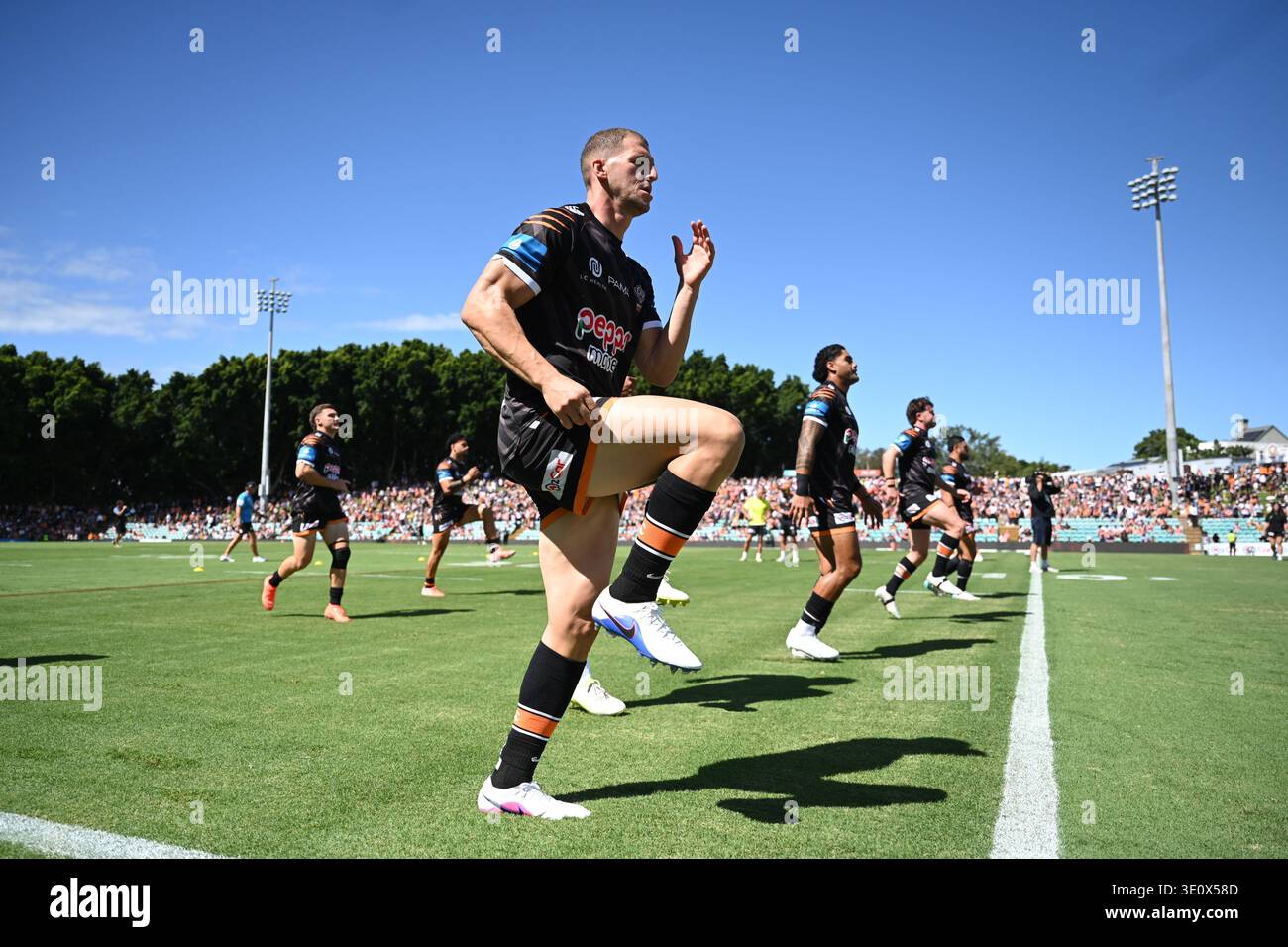 Adam Doueihi of the Tigers warms up ahead of the NRL Round 2 match ...