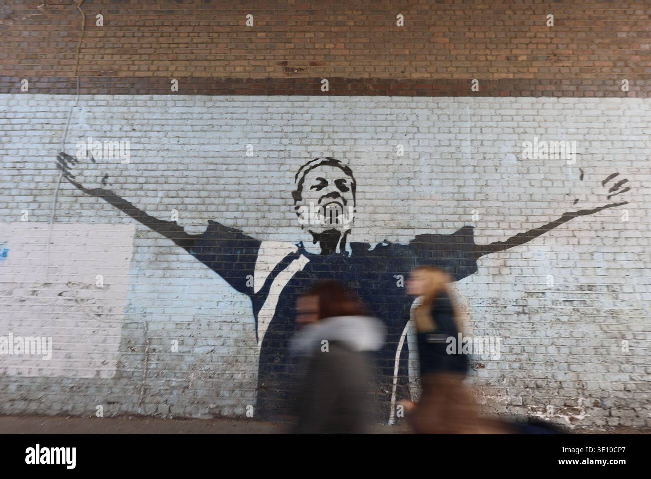 Fans walk past a mural of Neil Harris outside Millwall Football Club ...