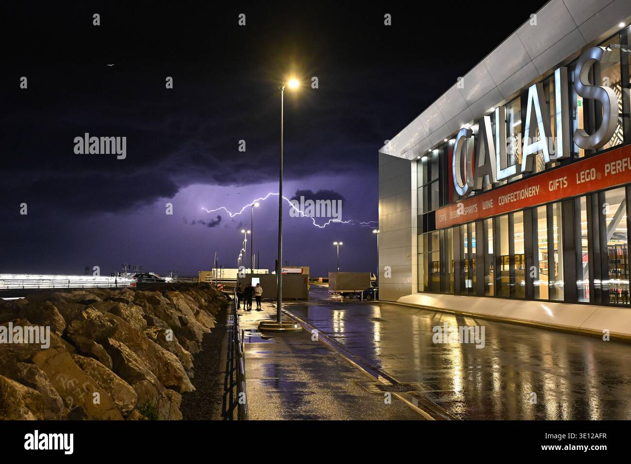 A powerful lightning bolt illuminates the sky over the Port of Calais ...