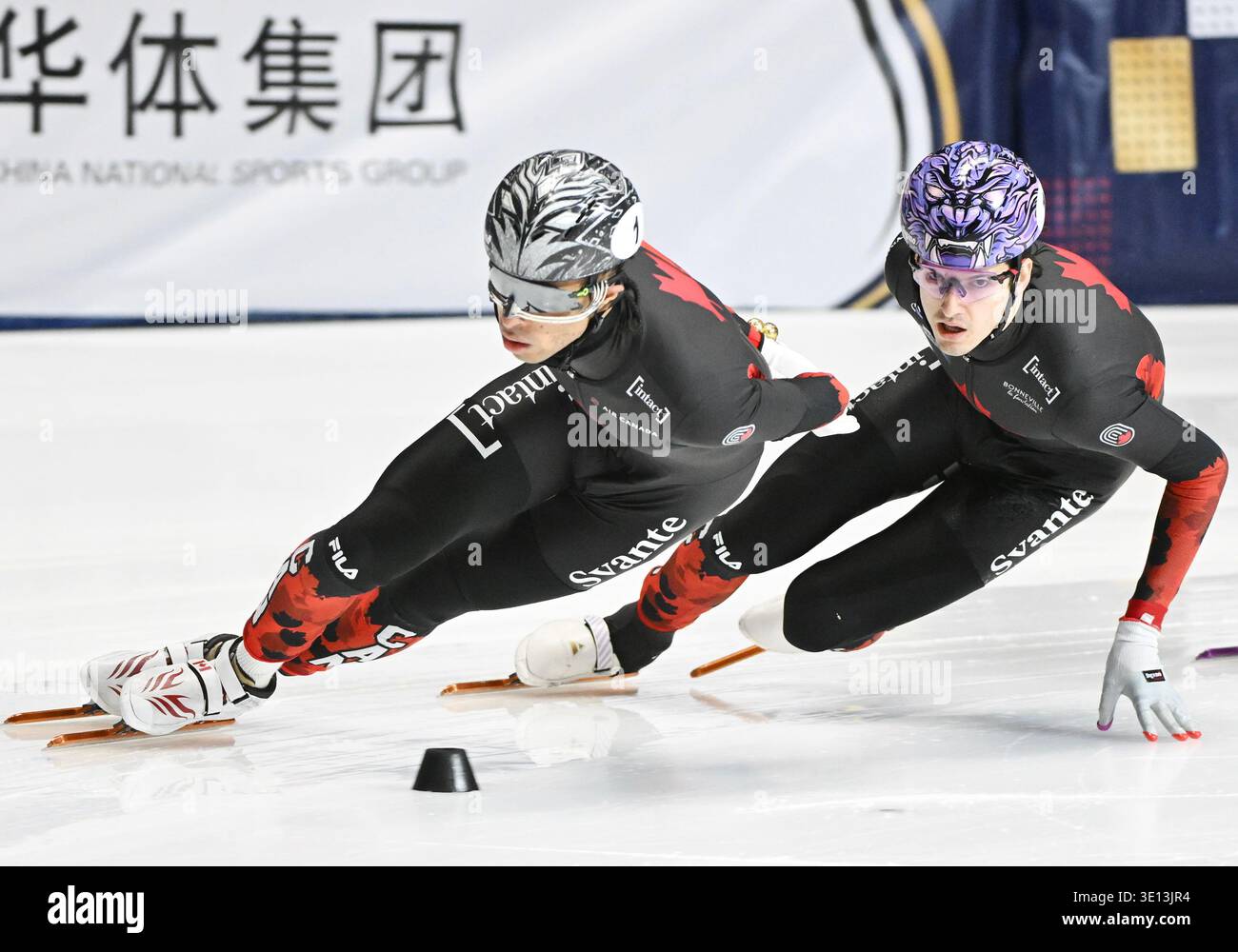 William Dandjinou of Canada, left, takes a turn ahead of countryman ...