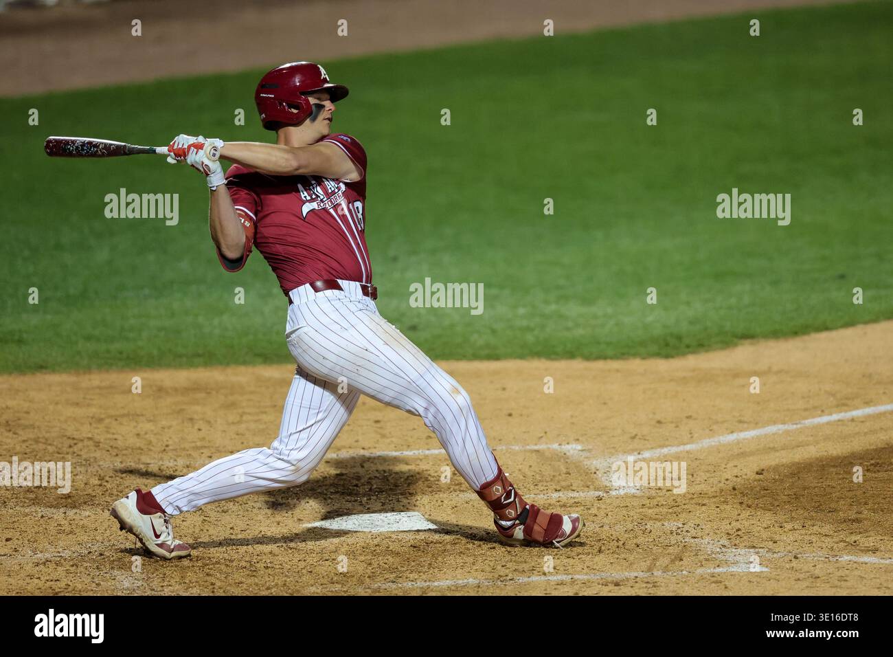 March 14, 2026: Reese Robinett (18) of Arkansas finishes up his swing ...