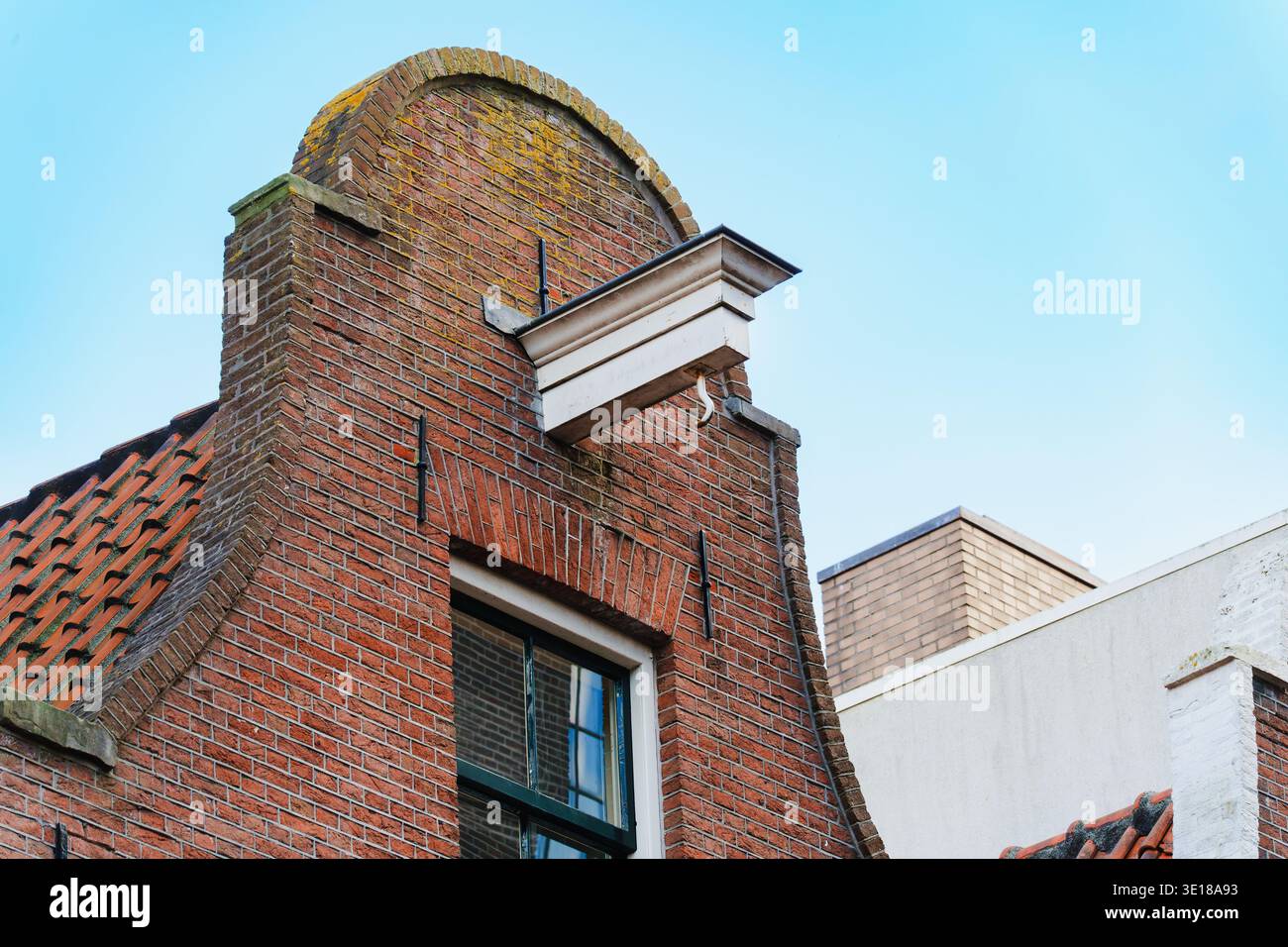 Traditional Dutch brick house with hoisting hook used to lift furniture ...