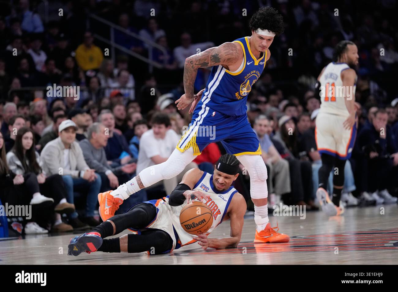 Golden State Warriors' Gui Santos, top, fouls New York Knicks' Josh ...