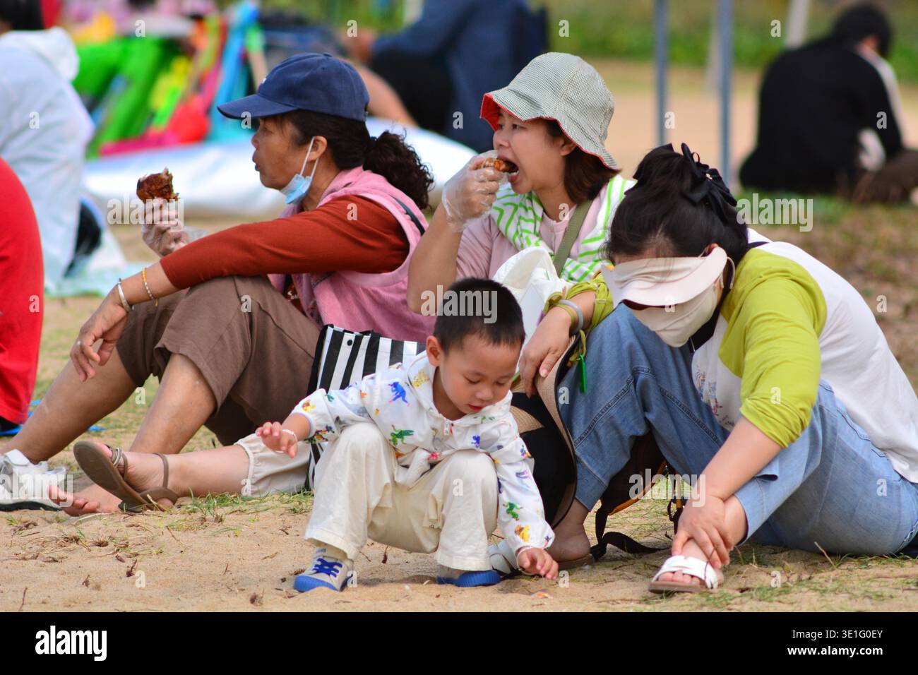 Tourists enjoy beach activities during spring season in Sanya Bay ...