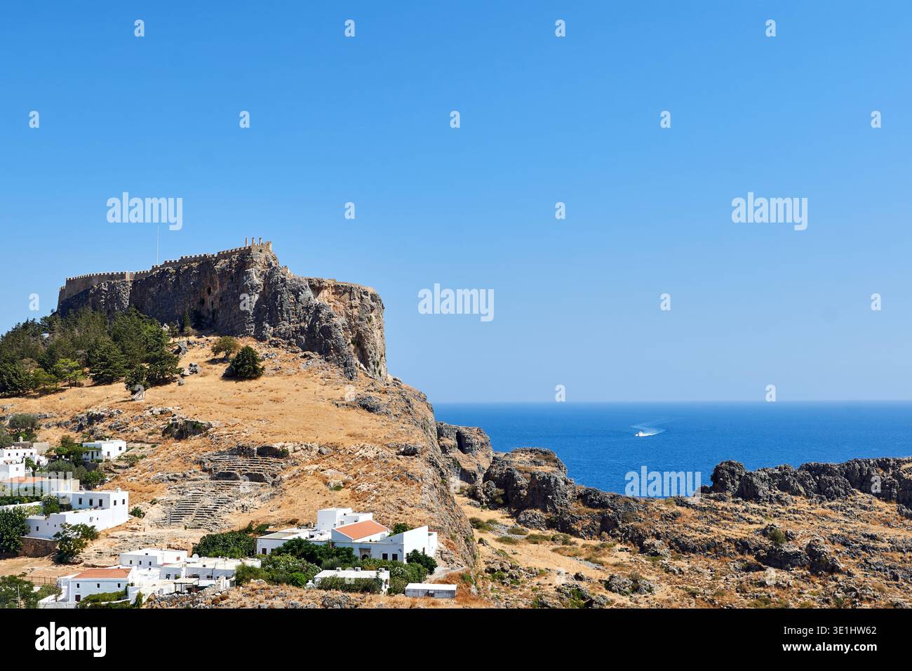 The white houses of Lindos and the ruins of the ancient amphitheater at ...