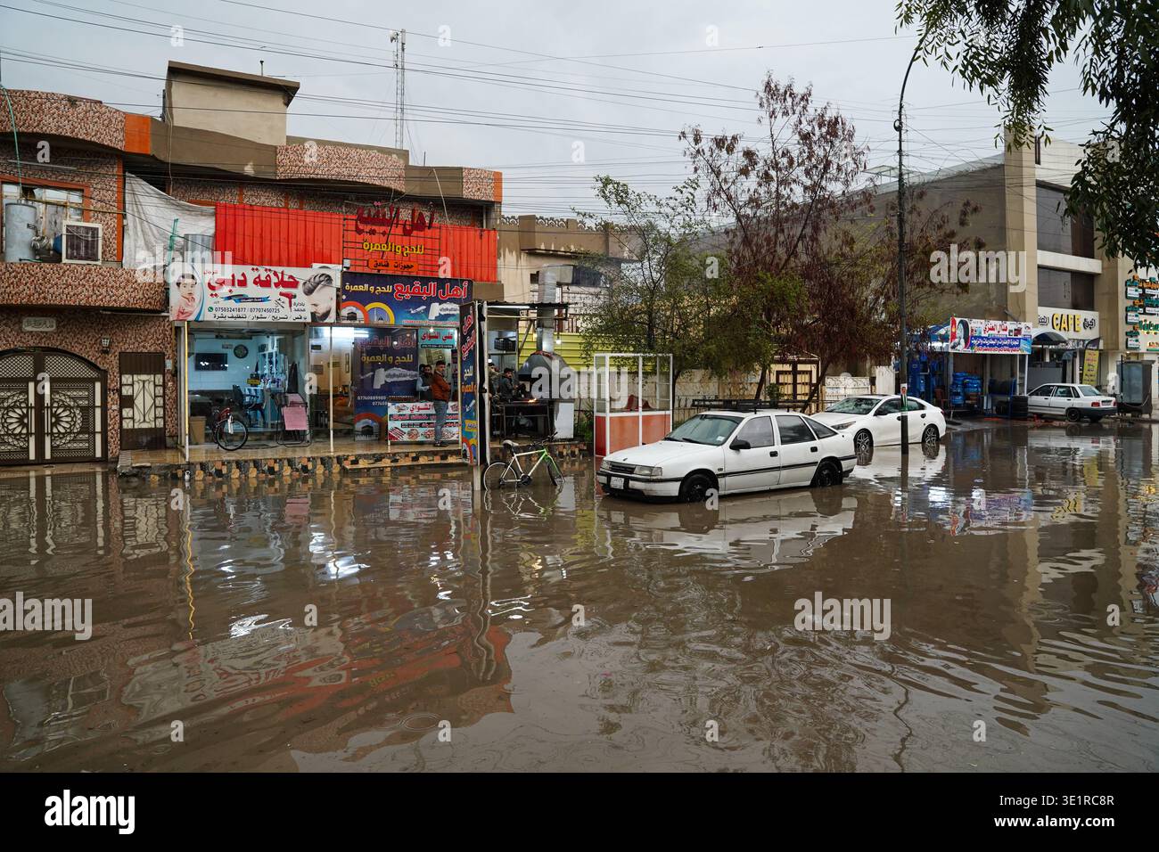 A car parked in a flooded street in Mosul after heavy rains caused ...