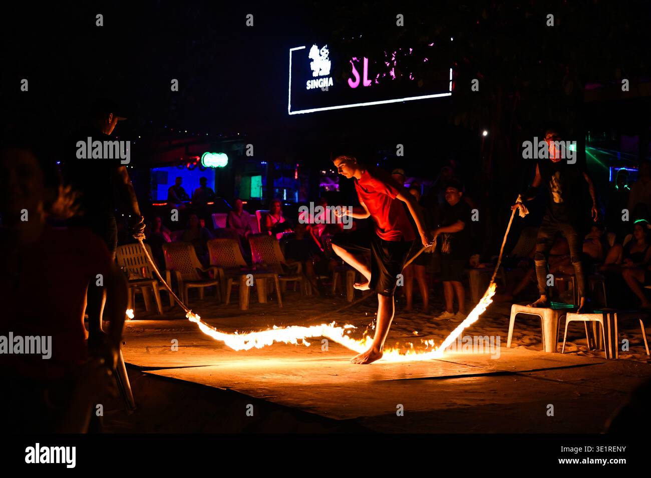 Tourists enjoying a fire limbo activity on Loh Dalum Beach, Phi Phi ...
