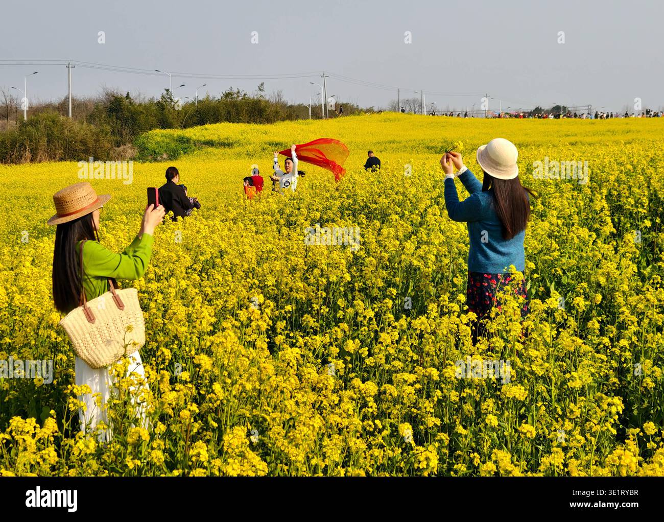 Tourists visit rapeseed flower fields in full bloom in Lu'an City, east ...