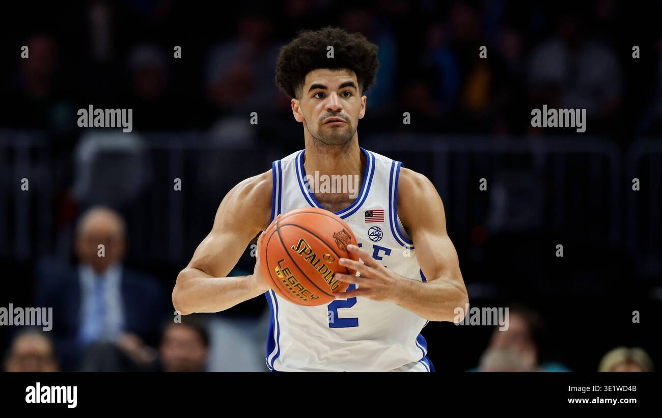 Duke guard Cayden Boozer passes against Virginia during the first half ...