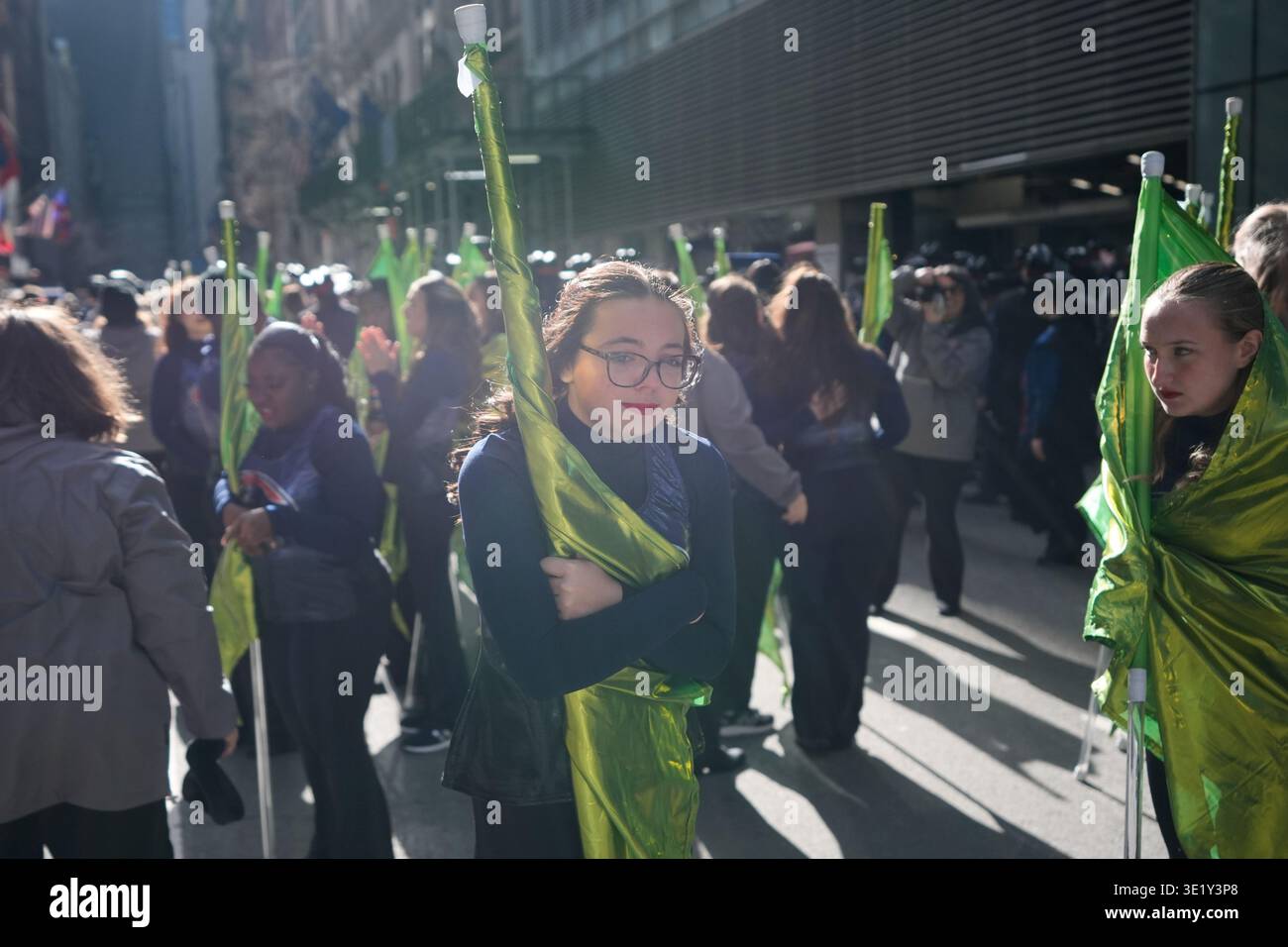 Miranda Parrish, 16, tries to keep warm before marching with her high ...