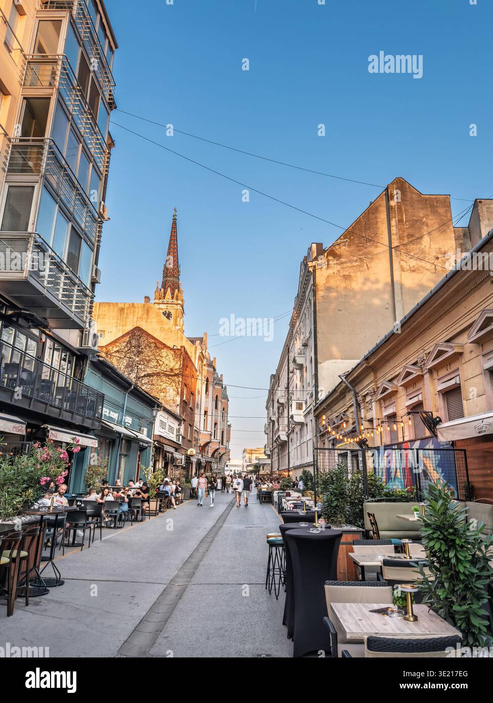 NOVI SAD, SERBIA - JUNE 14, 2025: Restaurants and outdoor tables line ...