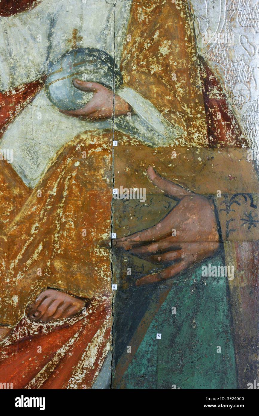 Restoration work is being done on an ancient canvas fragment using ...