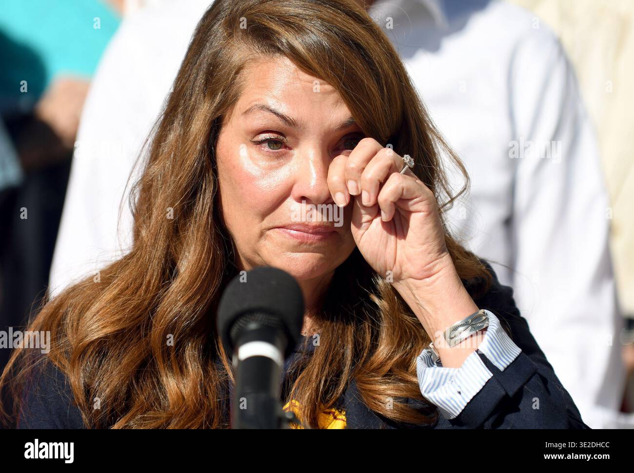 City Council President Amanda Sandoval wipes her eyes during a news ...