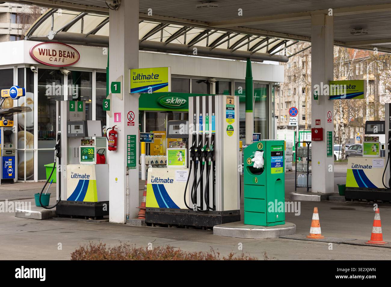 Modern gas station with fuel dispensers, BP Ultimate signage, Wild Bean ...