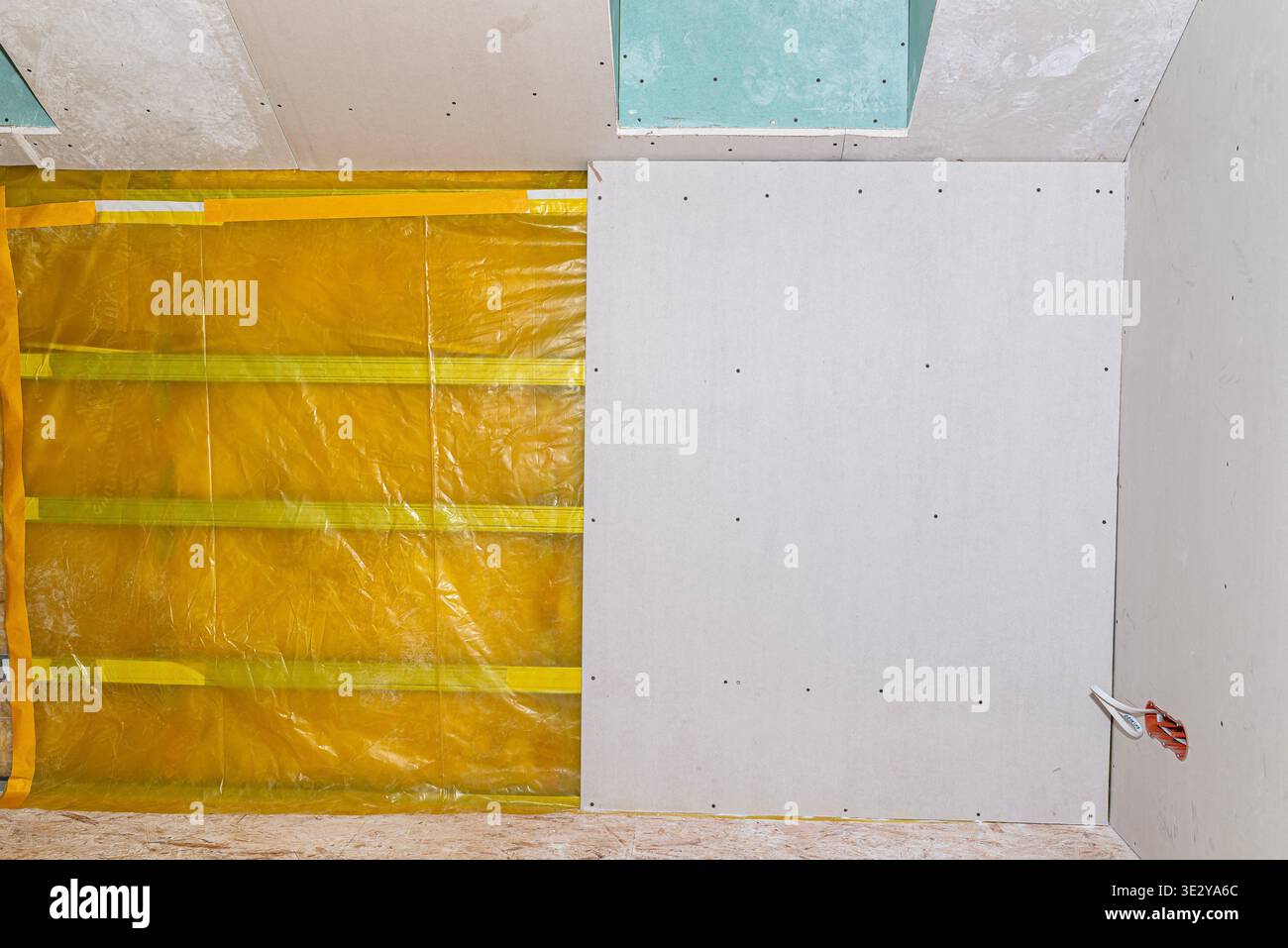 Building wall section with vapor barrier foil and plasterboard sheets ...