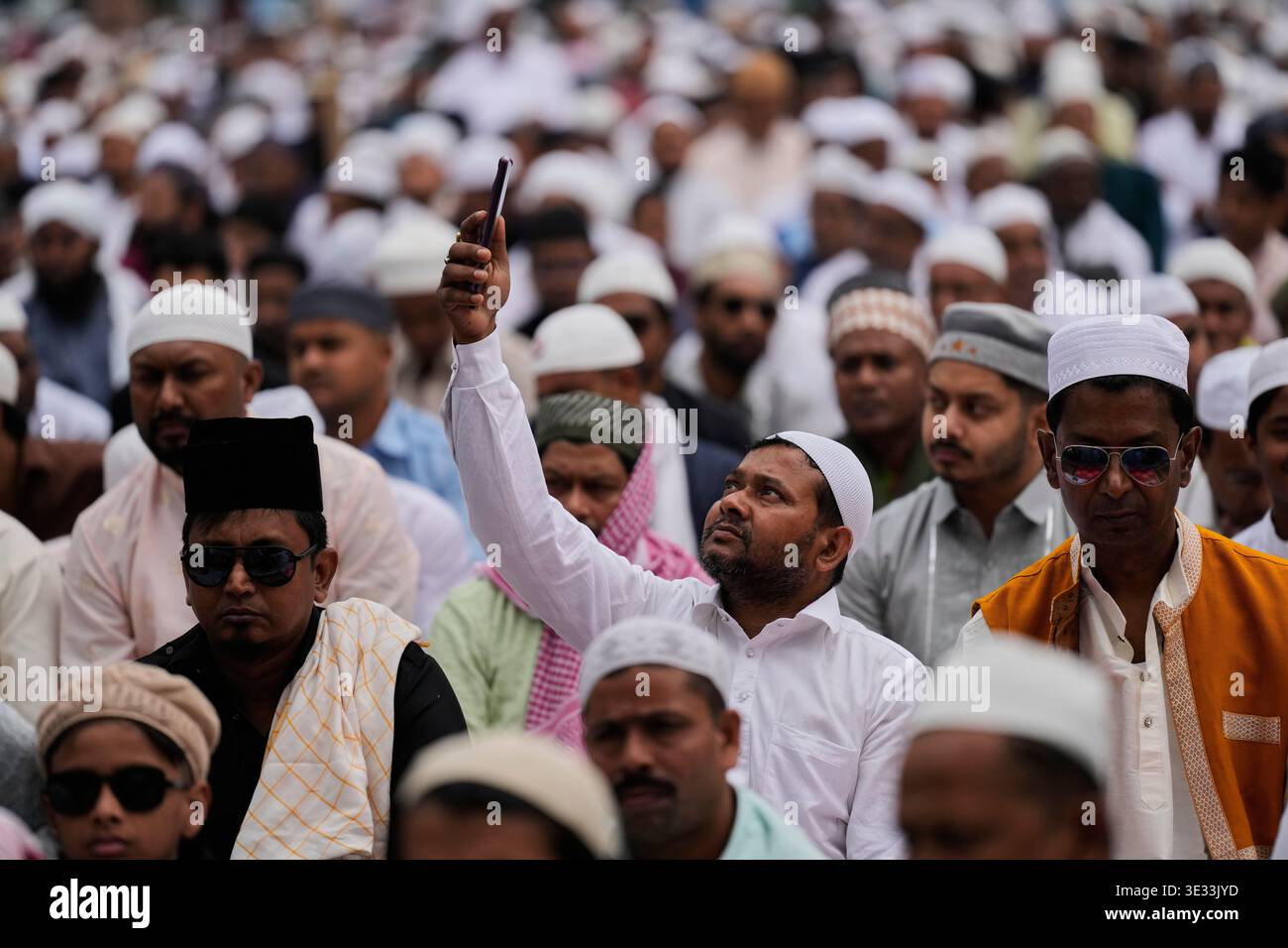 A man takes a selfie as worshippers wait to offer Eid al-Fitr prayers ...