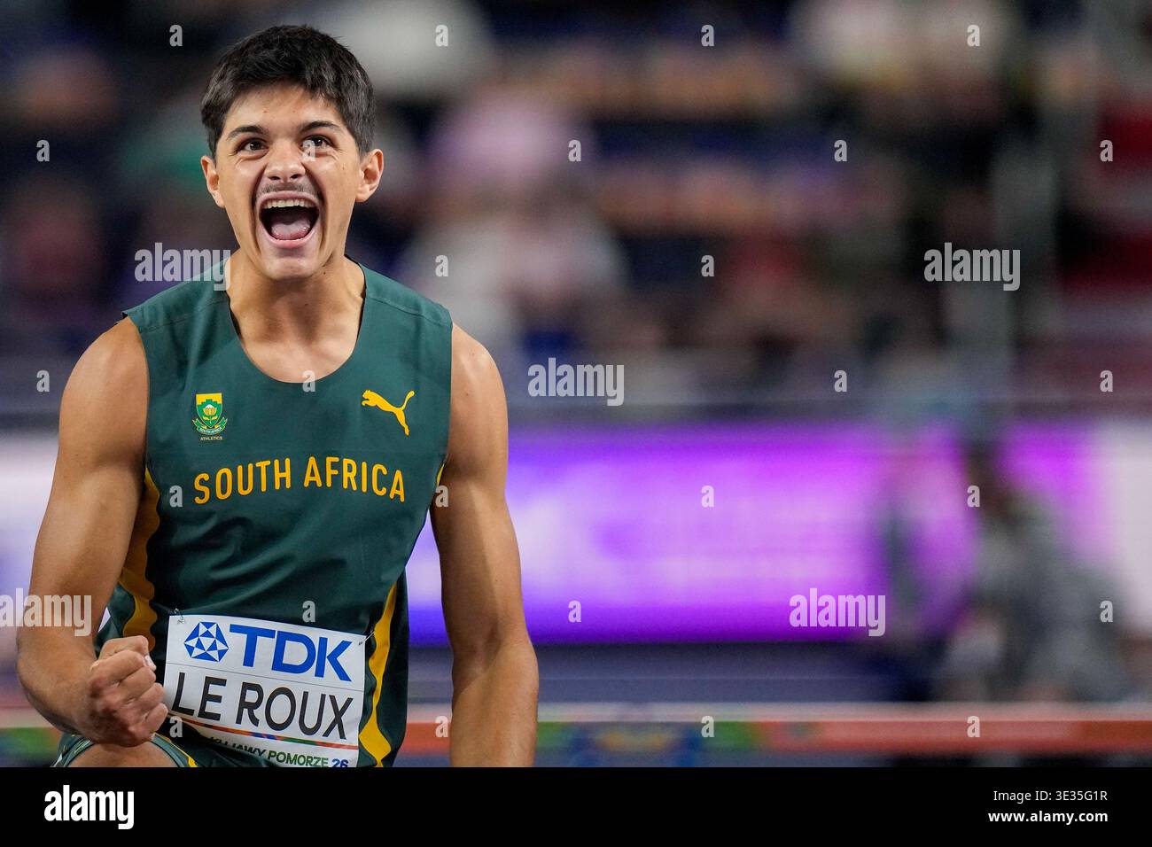 Franco Le Roux, of South Africa, reacts after crossing the finish line ...