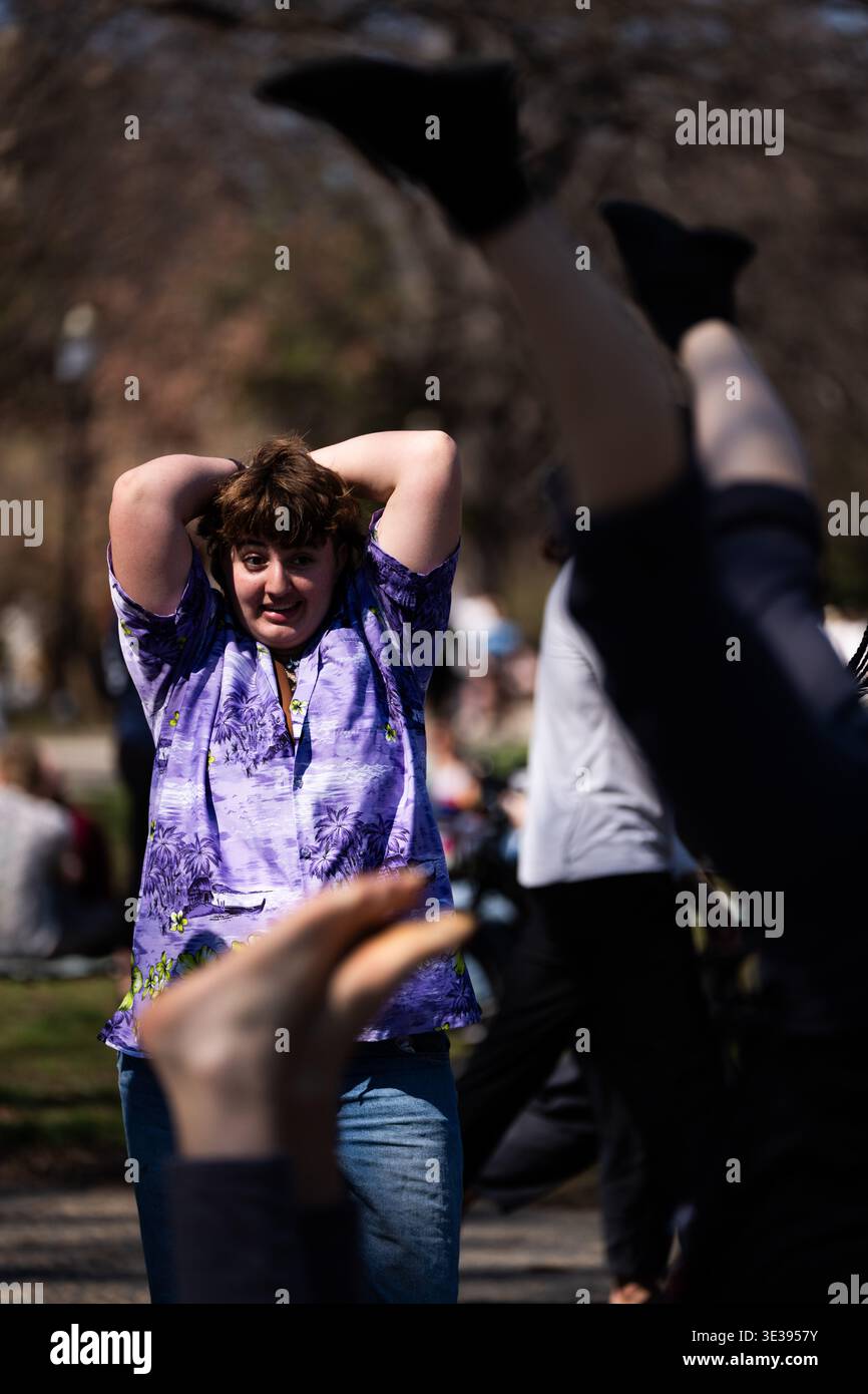 An individual watches members of DC Acro Yogis exercise at Meridian ...