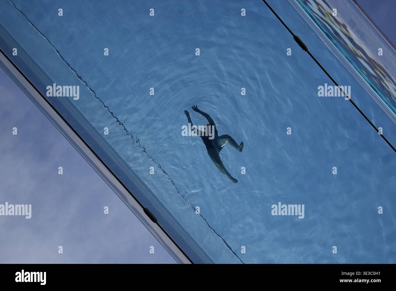 A swimmer in the Sky Pool, a transparent swimming pool suspended 35 ...