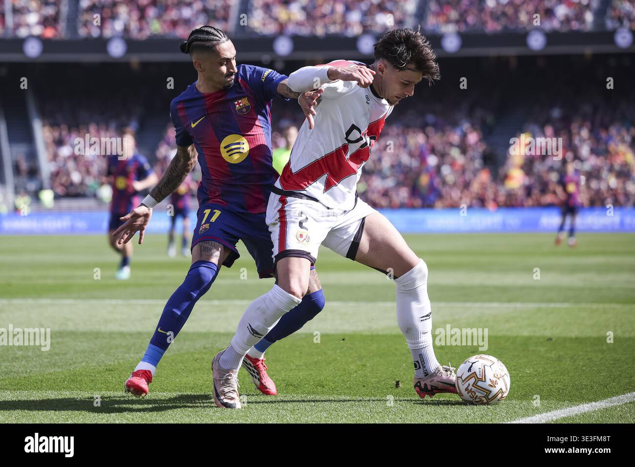 Andrei Ratiu of Rayo Vallecano and Raphinha of FC Barcelona during the ...