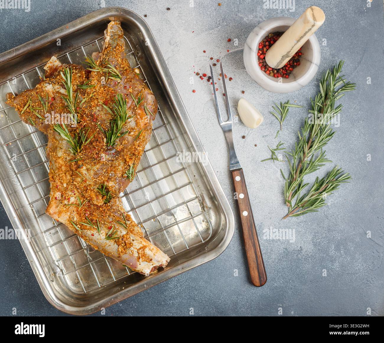 Raw roe deer leg with spices, garlic and rosemary for baking. Delicious ...