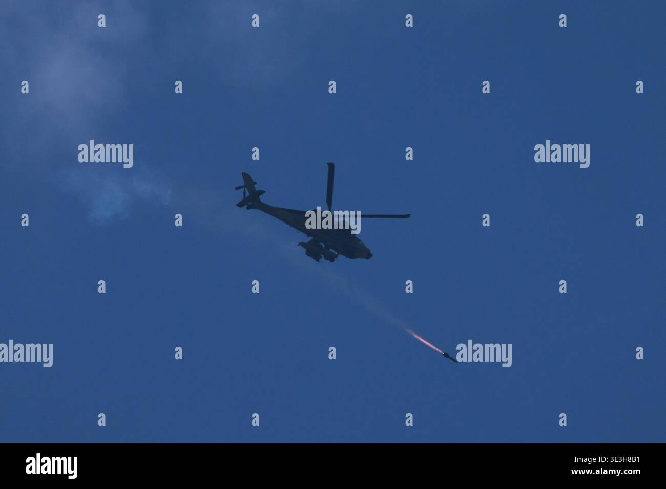 An Israeli Apache helicopter fires a missile towards southern Lebanon ...