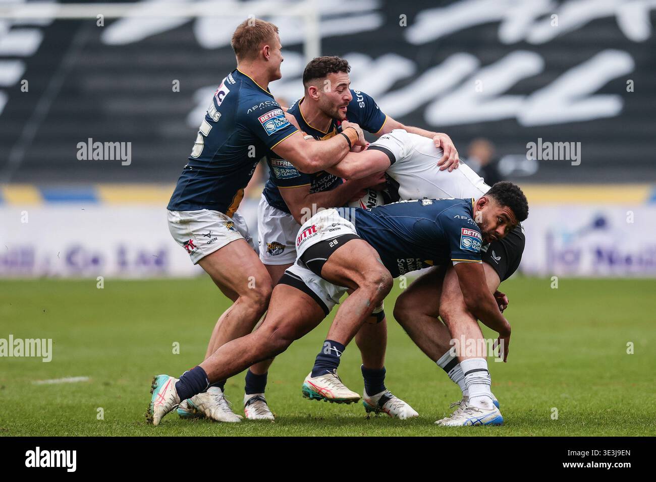 Connor Bailey of Hull FC is tackled by Kallum Watkins of Leeds Rhinos ...